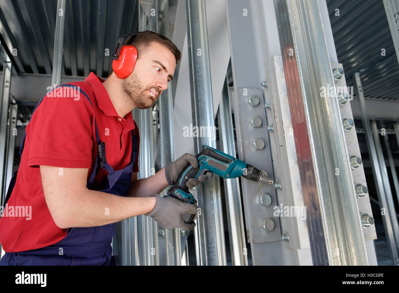 Young man using drill machine hi-res stock photography and images - Alamy