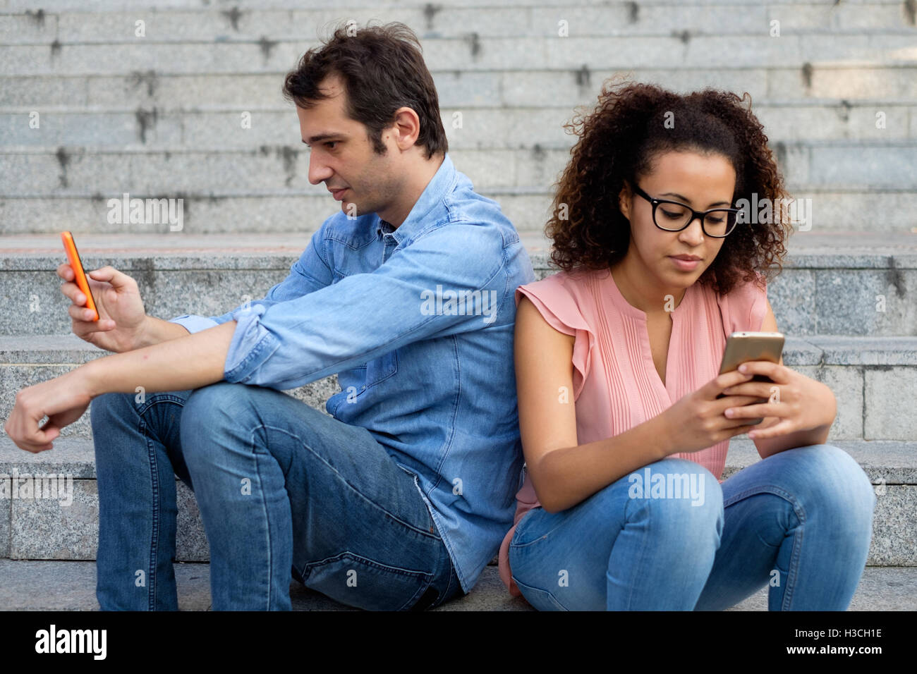 Female friends using mobile phones hi-res stock photography and images ...