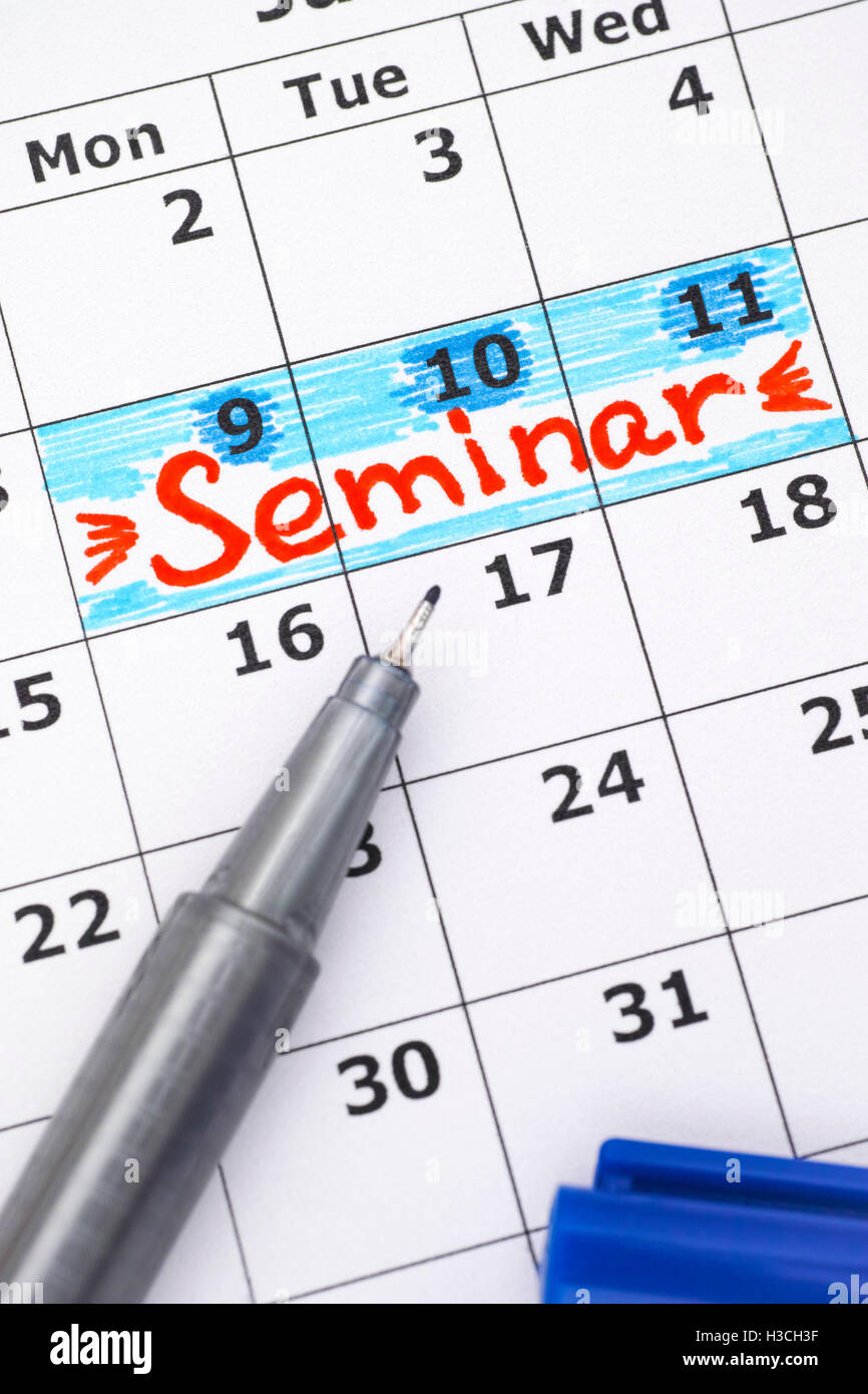 Reminder Seminar in calendar with blue pen Stock Photo - Alamy