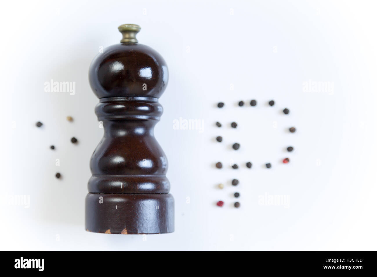 Classical wood pepper shaker against a white background Stock Photo - Alamy