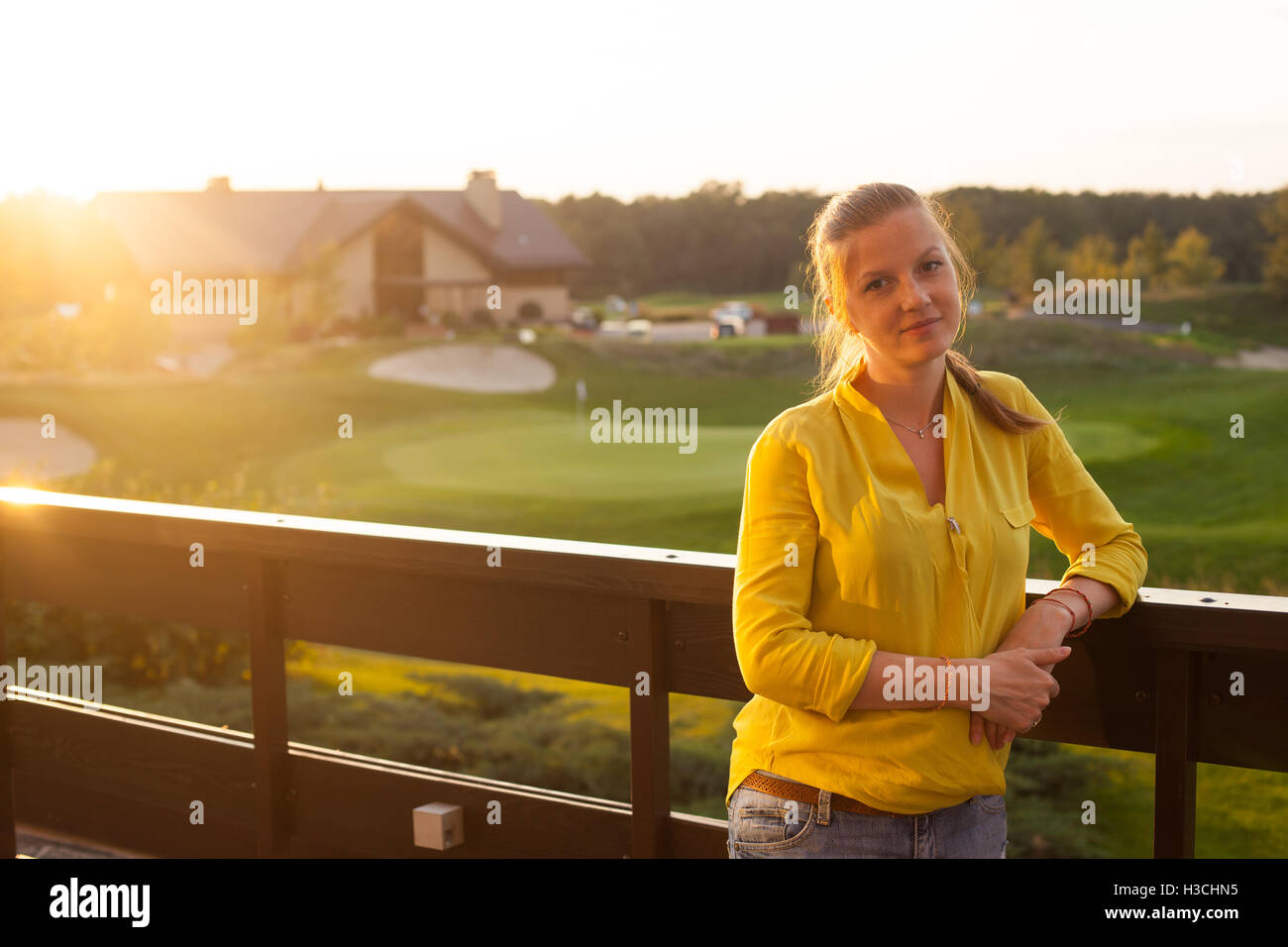 Woman standing on wooden terrace hi-res stock photography and images ...