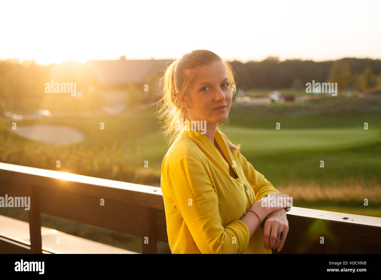 Woman standing on wooden terrace hi-res stock photography and images ...