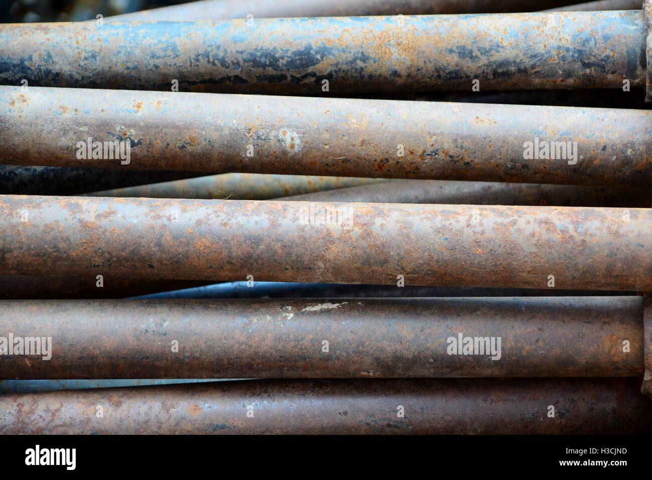 Grunge rusty old metal tubes at construction site Stock Photo - Alamy