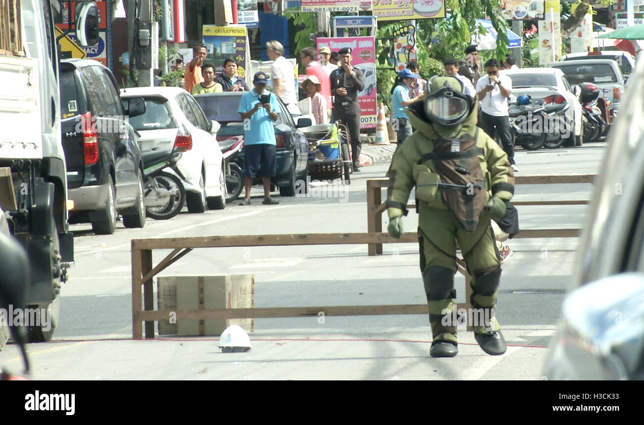 Thai police bomb squad prepare to detonate a bomb near the clock tower ...