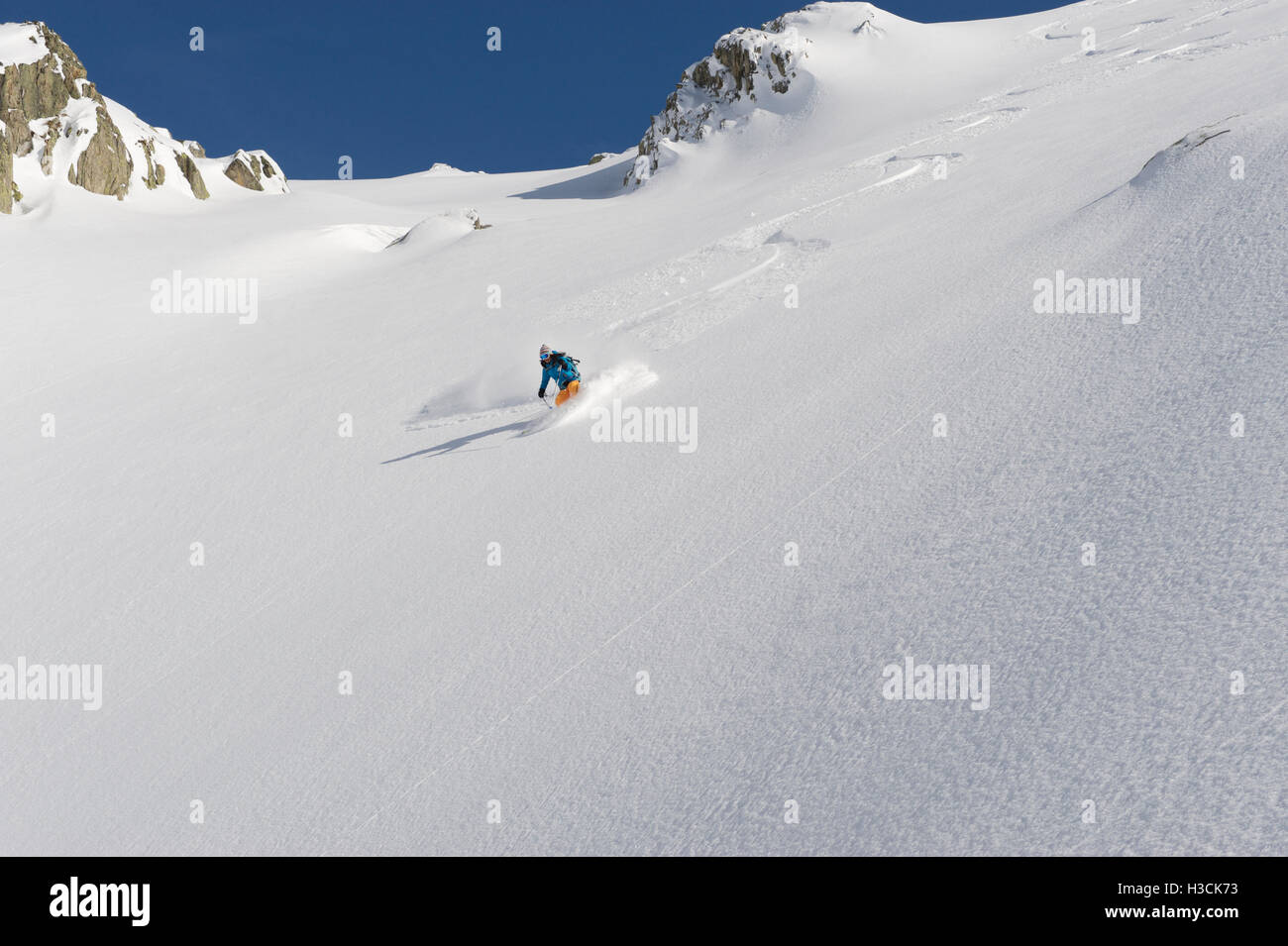 Skier on steep slope hi-res stock photography and images - Alamy