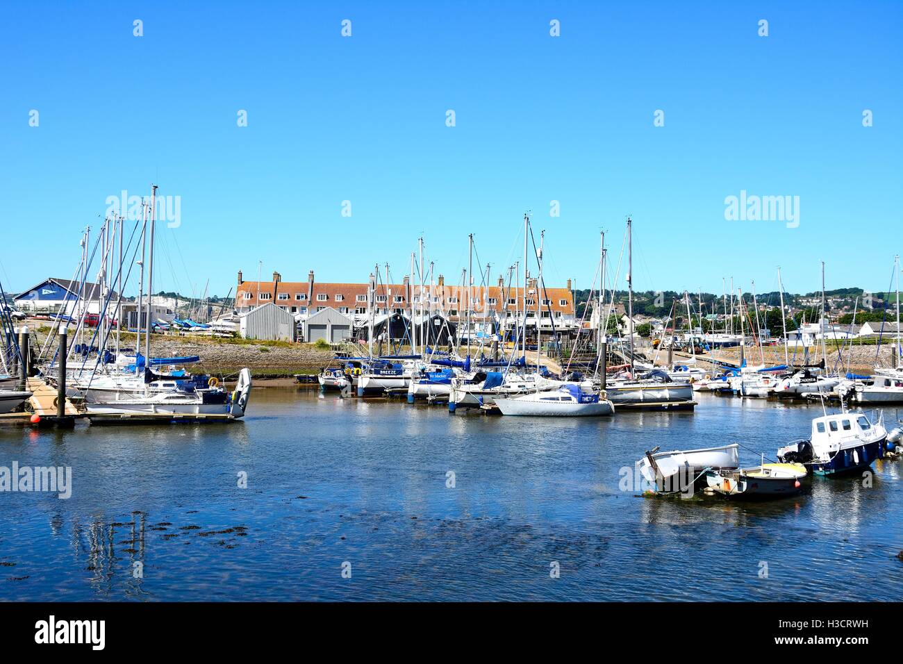 Yachts and fishing boats moored in the harbour, Axmouth, Devon, England ...
