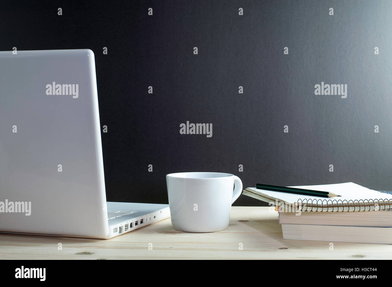 Workplace with laptop coffee and book on wooden desk Stock Photo - Alamy