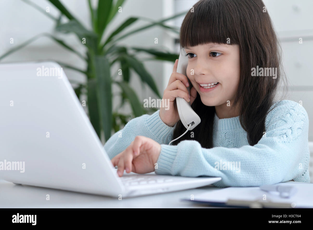 Little girl using computer Stock Photo - Alamy