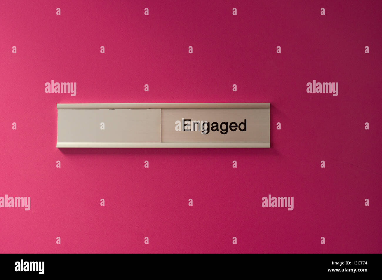 Gold engaged sign on a pink door Stock Photo - Alamy