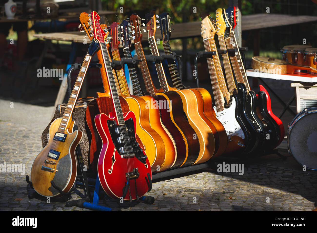 Few guitars at a flea market outdoor Stock Photo - Alamy