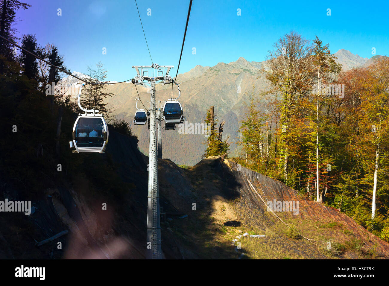 Mountain zipline through autumn forest on backdrop of Caucasus ...