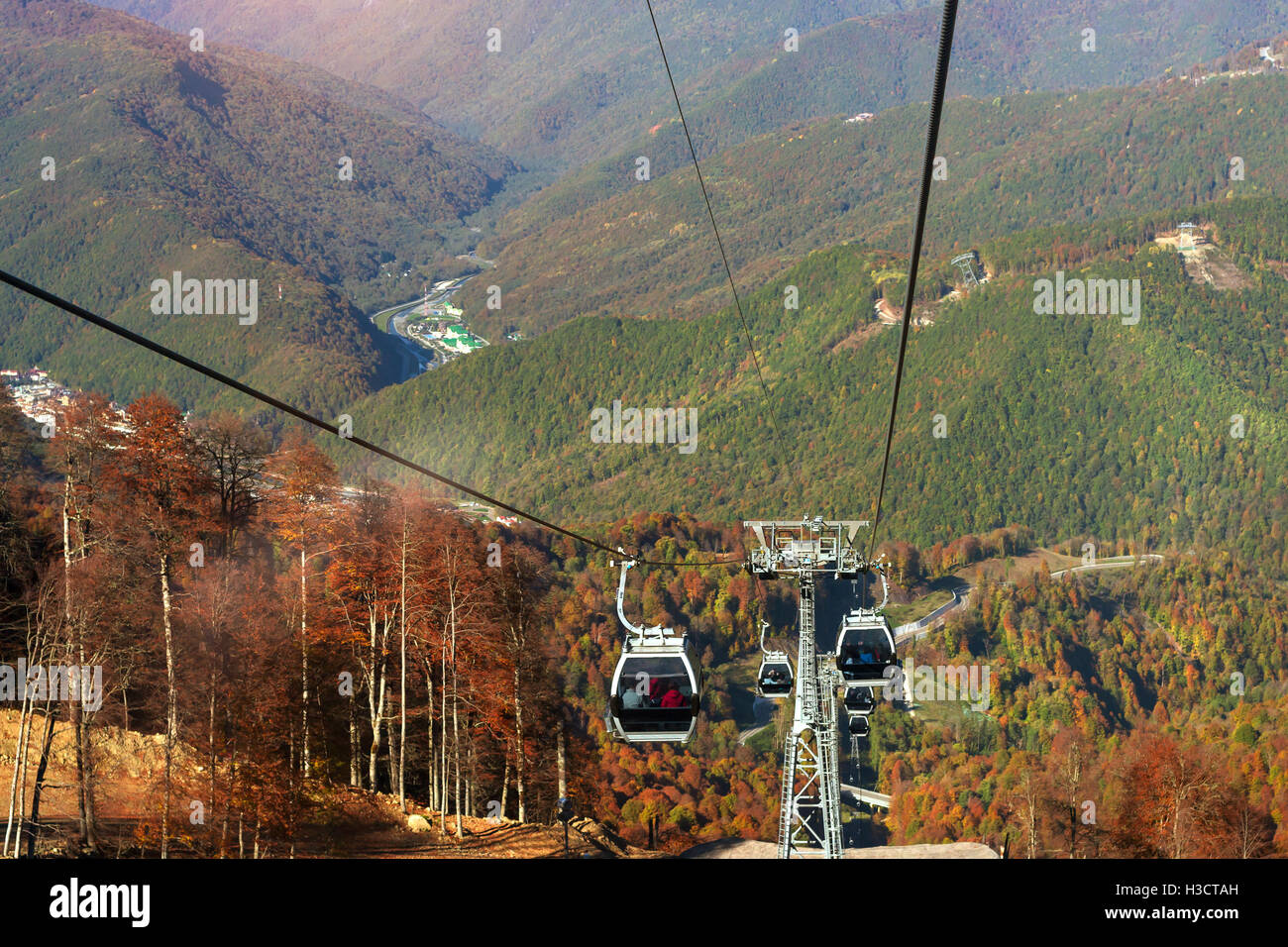 Mountain zipline through autumn forest on backdrop of Caucasus ...