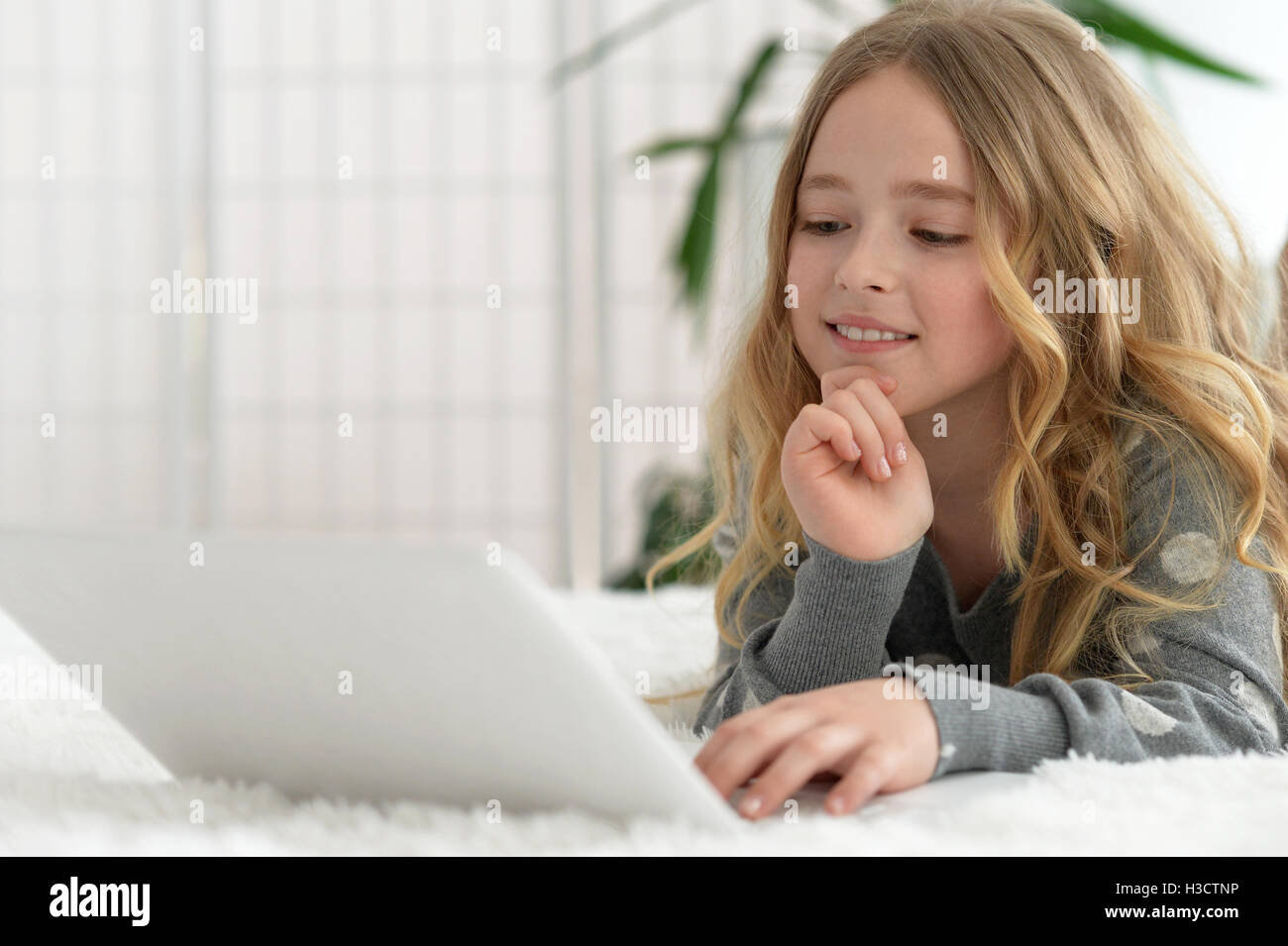 Little girl using computer Stock Photo - Alamy