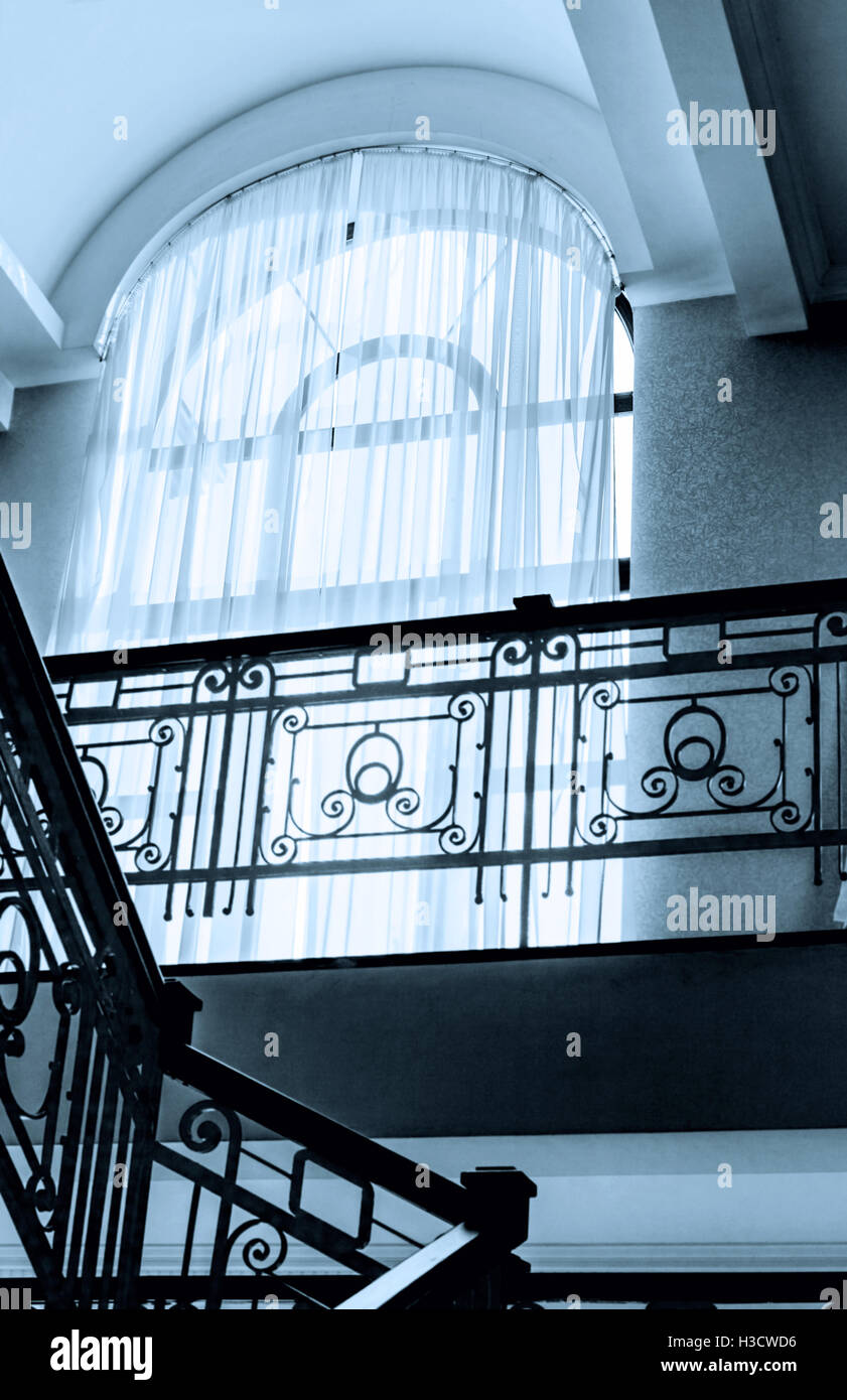 High window above stairs in house in blue tones Stock Photo - Alamy
