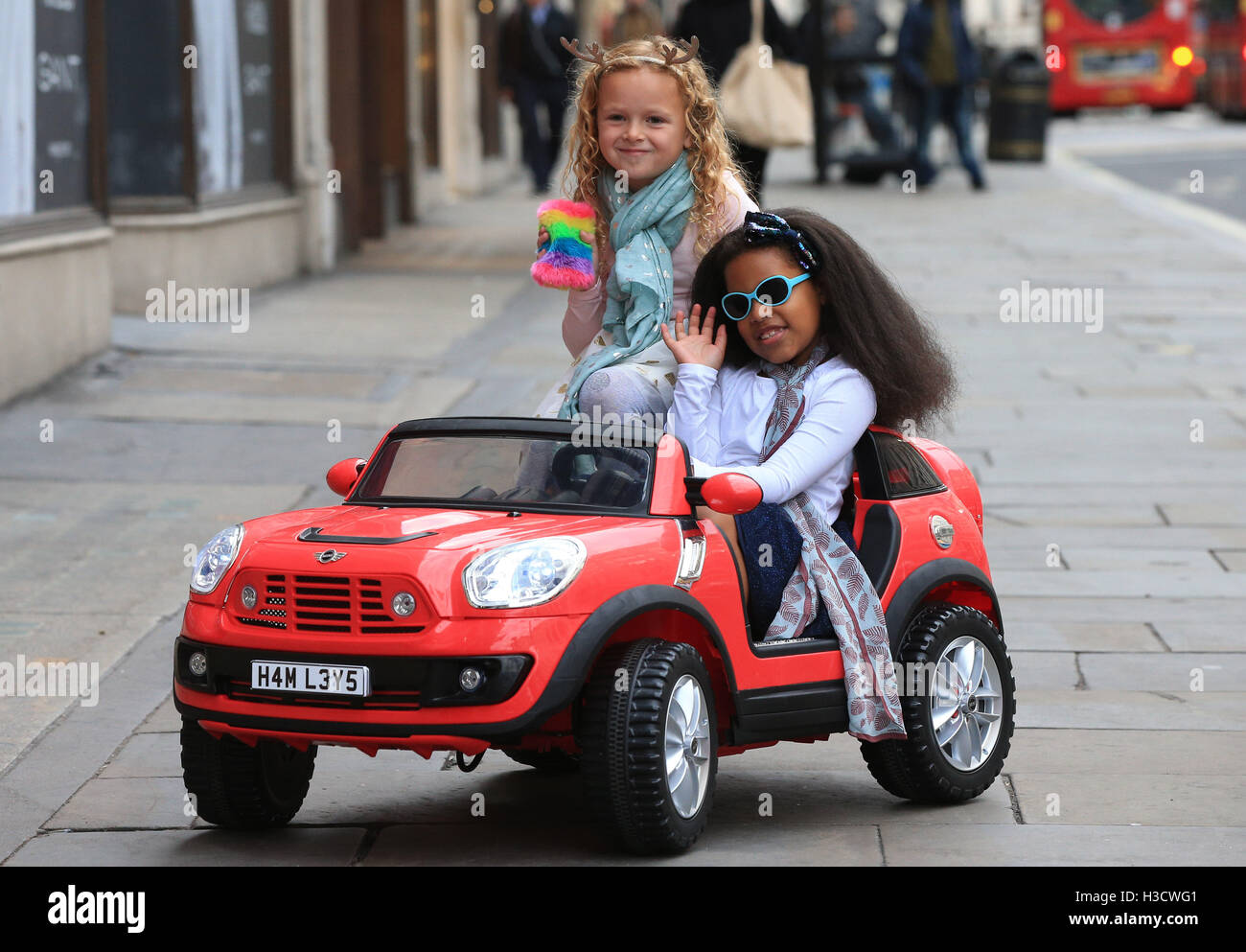 Ella Twigg (left), six, and Queenie Chappell, six, in a BMW Mini ...