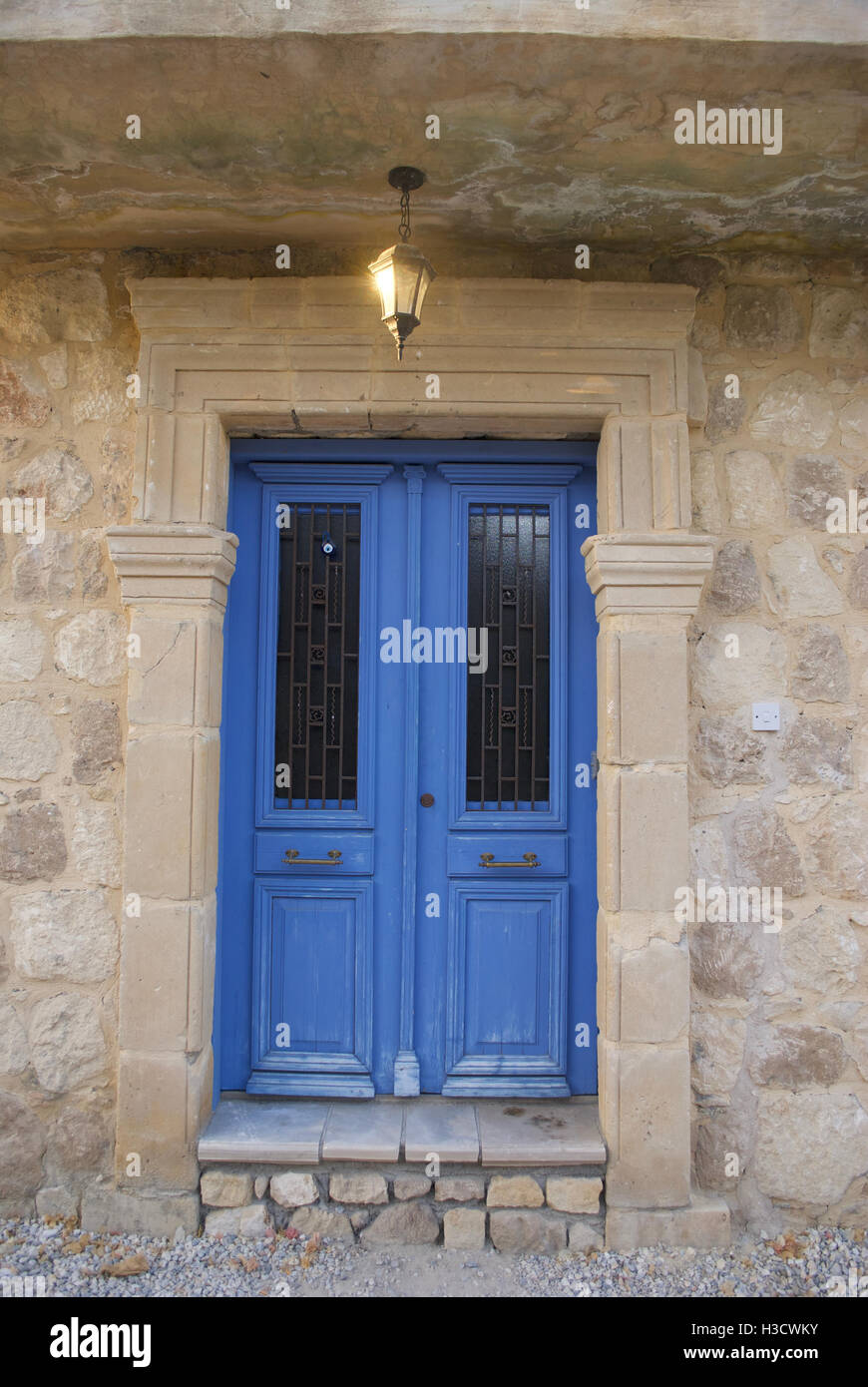 A rustic, blue wooden door and stone entrance way to a home in Northern ...