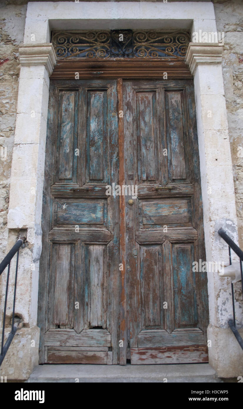 The rustic, wooden door of a building in North Cyprus framed by a light ...