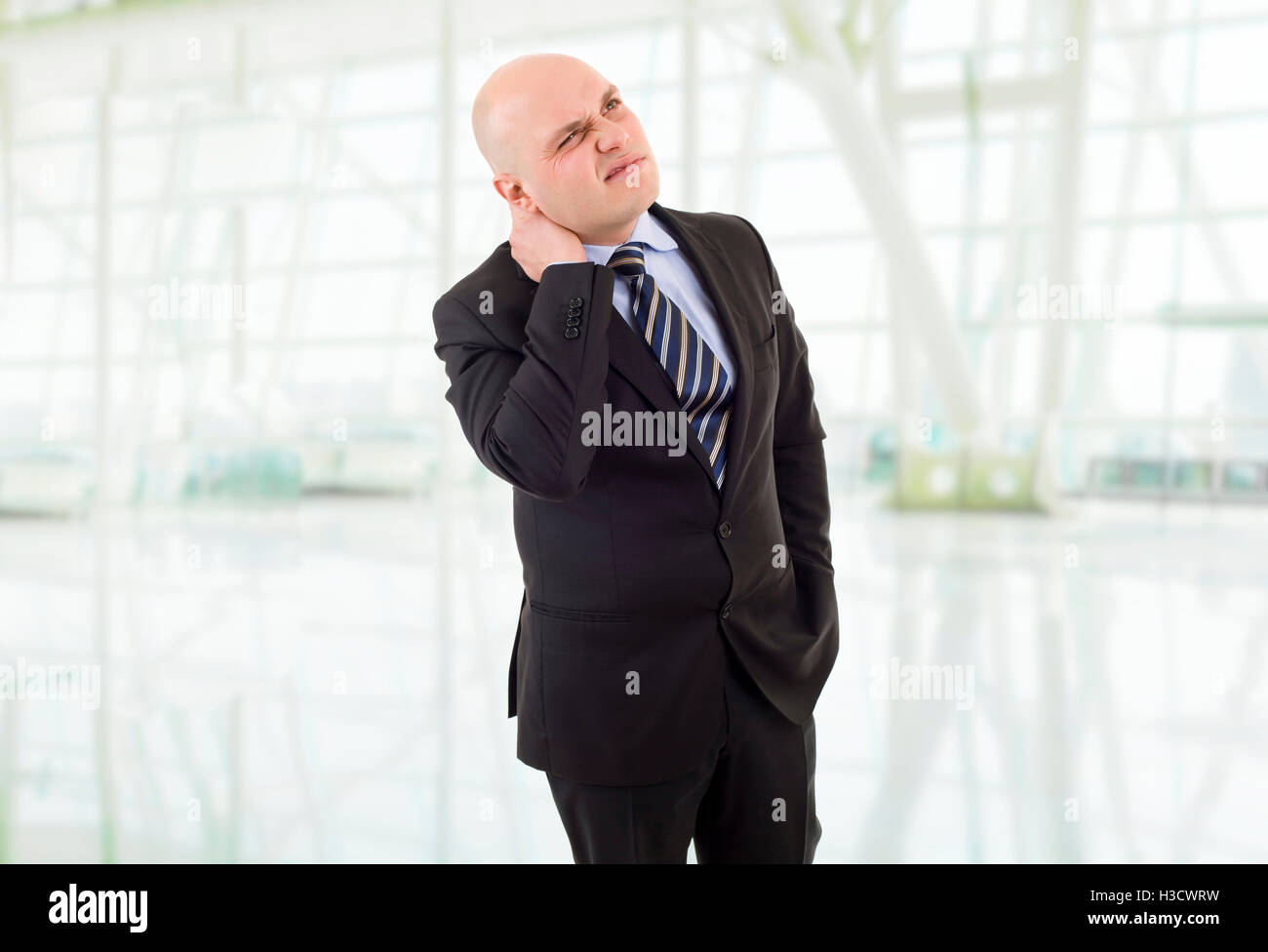 Young businessman with strong back pain, at the office Stock Photo - Alamy