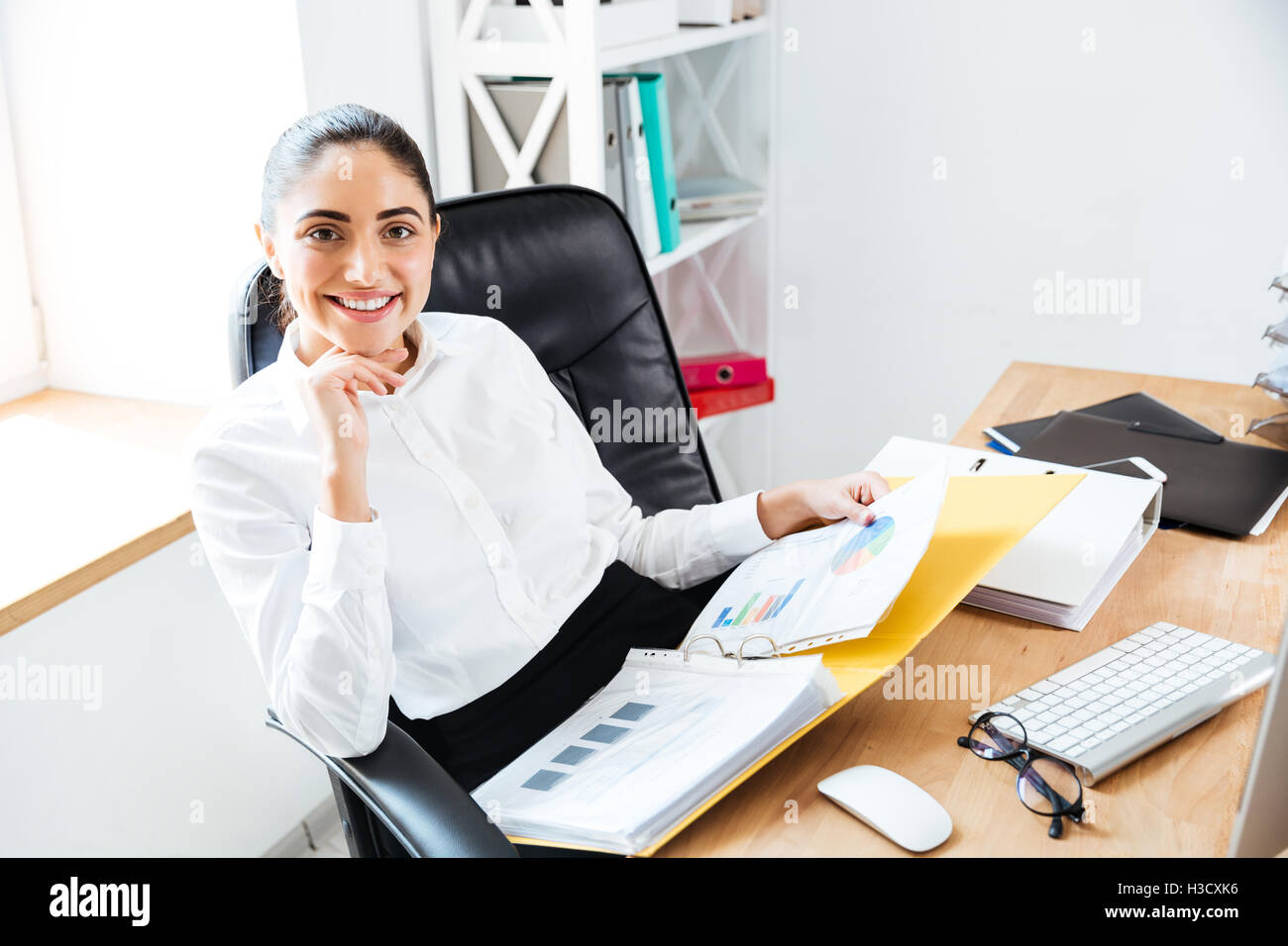 Business woman holding reports looking hi-res stock photography and ...