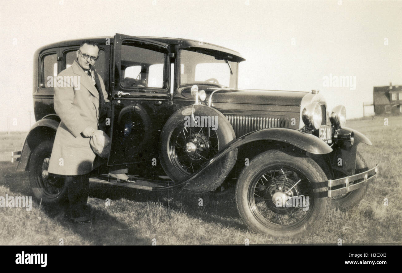 Antique c1930 photograph, man in overcoat poses with his foot on the ...