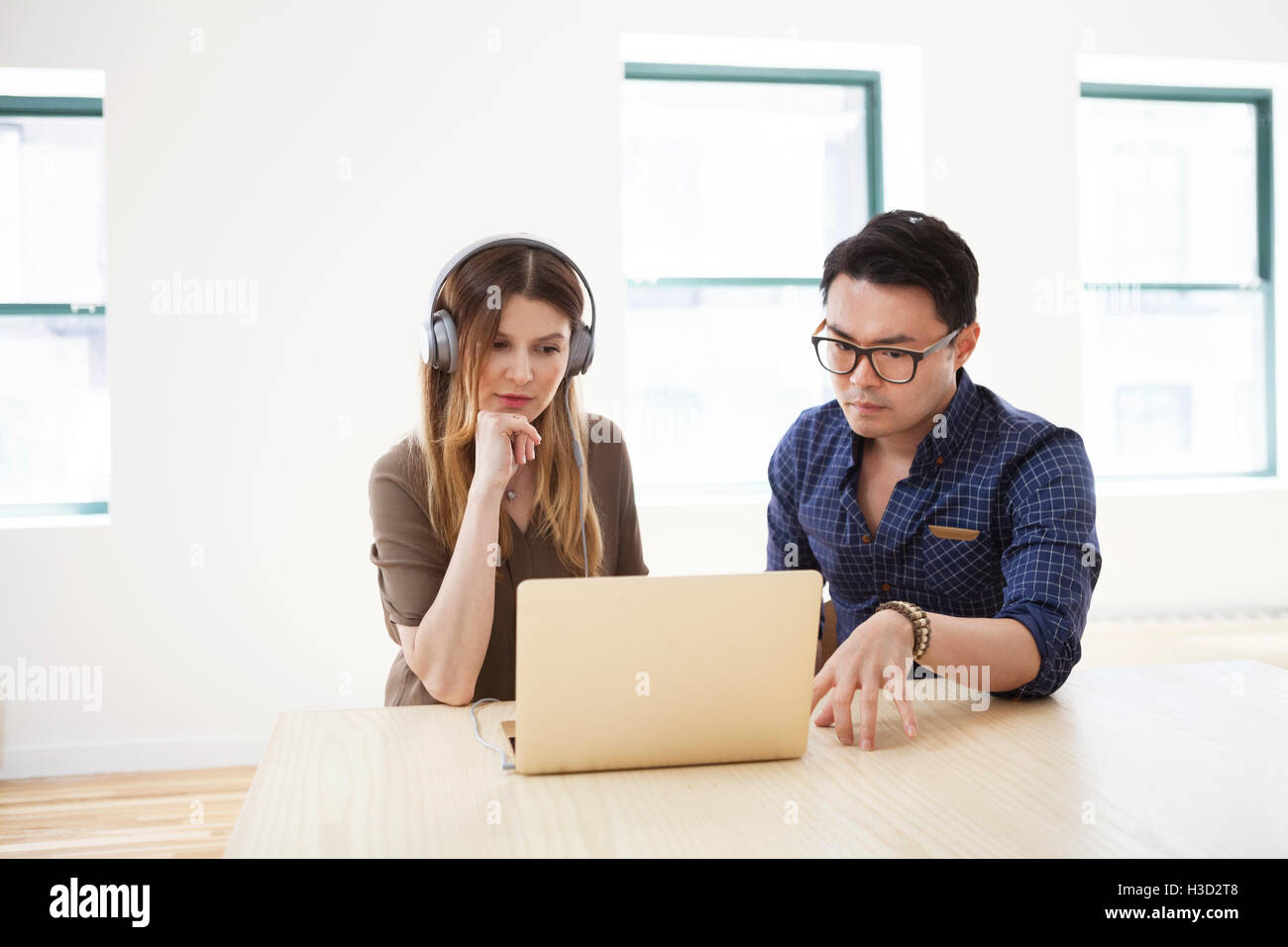 business people using laptop at desk in creative office Stock Photo - Alamy