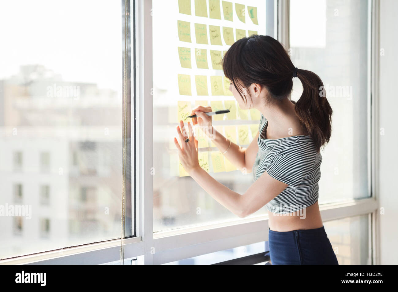 Asian woman writing notes hi-res stock photography and images - Alamy