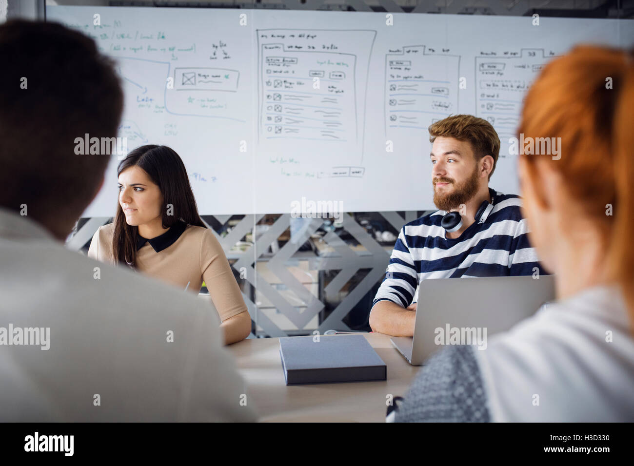 business people sitting at conference table in creative office Stock ...