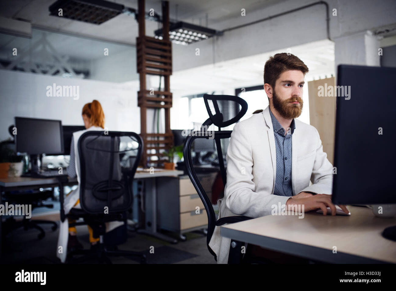 businessman using desktop computer in creative office Stock Photo - Alamy