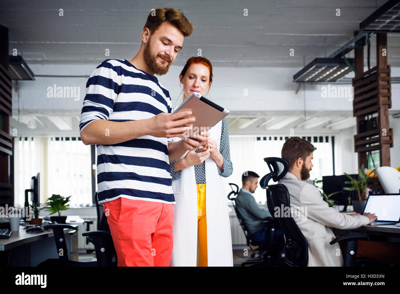 business people using tablet computer in creative office Stock Photo ...