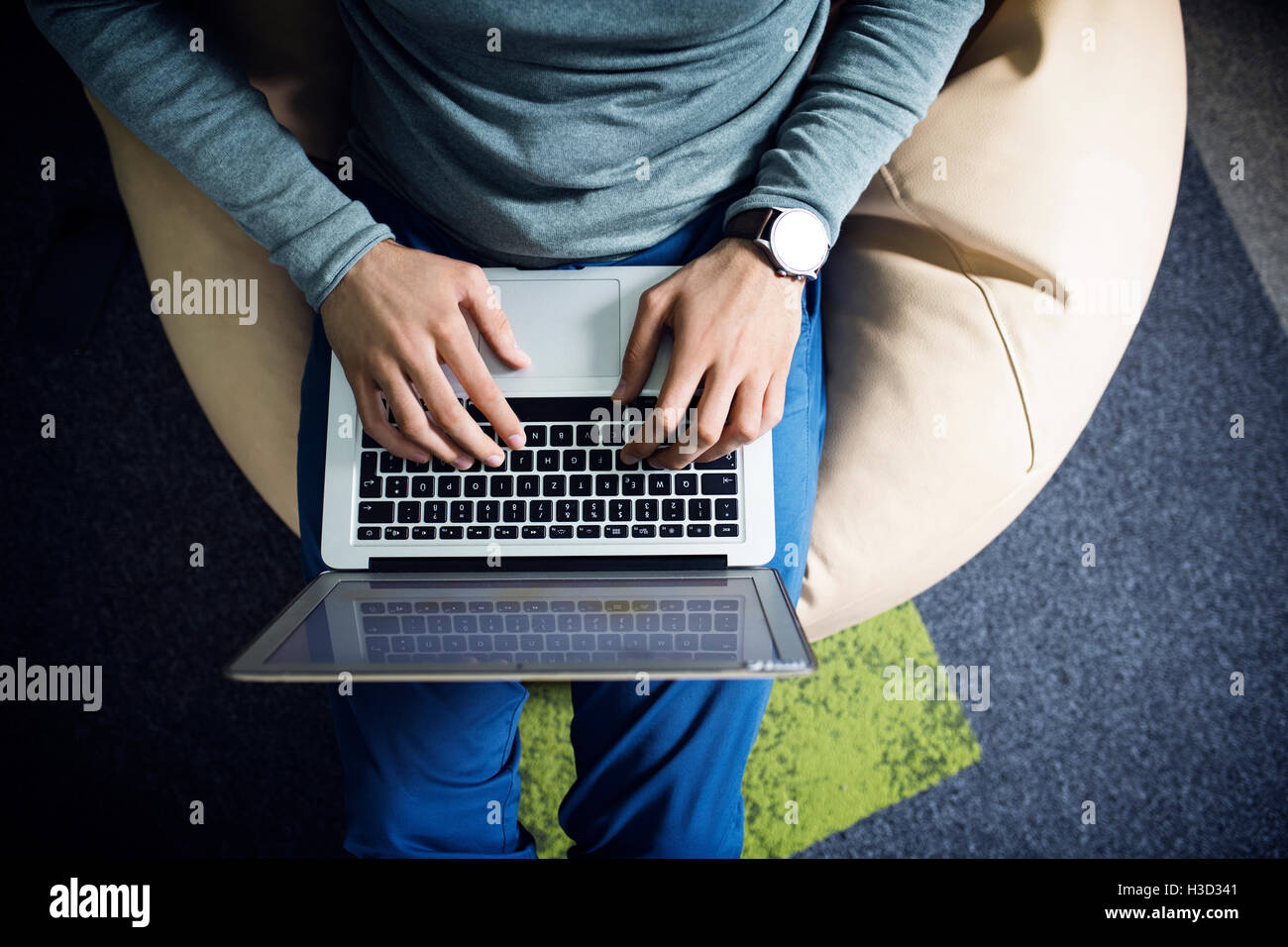 Overhead view of businessman using laptop in creative office Stock ...