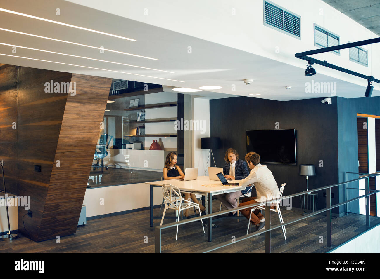 Business people using laptop during meeting in office Stock Photo - Alamy