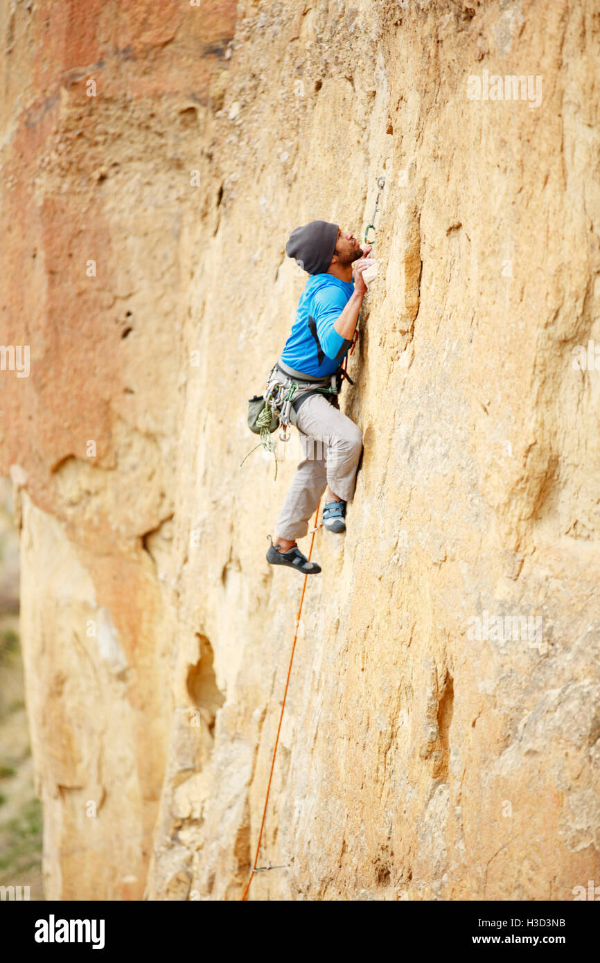 Side view of man climbing mountain Stock Photo - Alamy