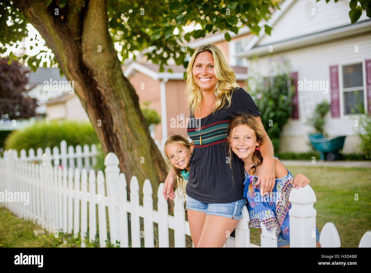 Portrait of happy family in backyard Stock Photo - Alamy