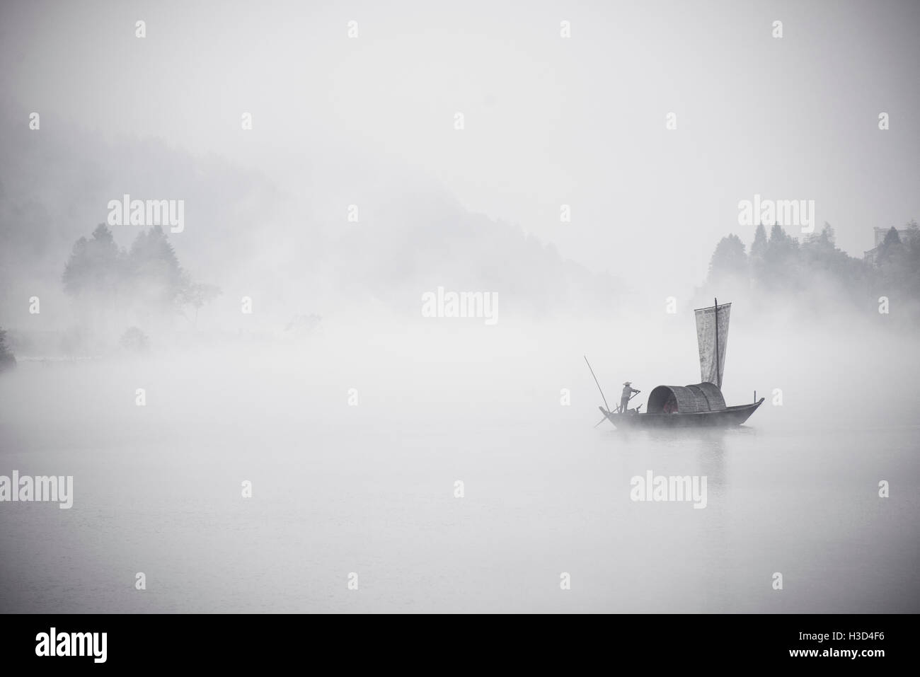 Man rowing traditional Chinese boat in lake Stock Photo - Alamy