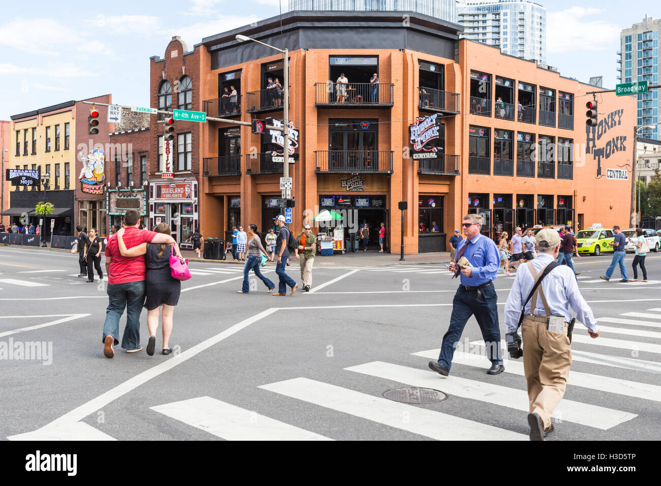 Pedestrians walk across an intersection with a pedestrian scramble on ...