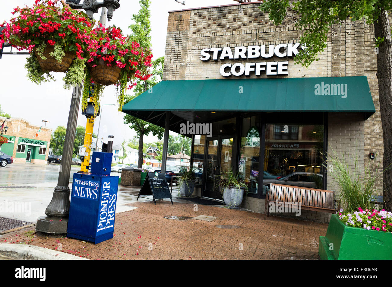 Decorative entrance to Starbucks Coffee house with red flowering ...