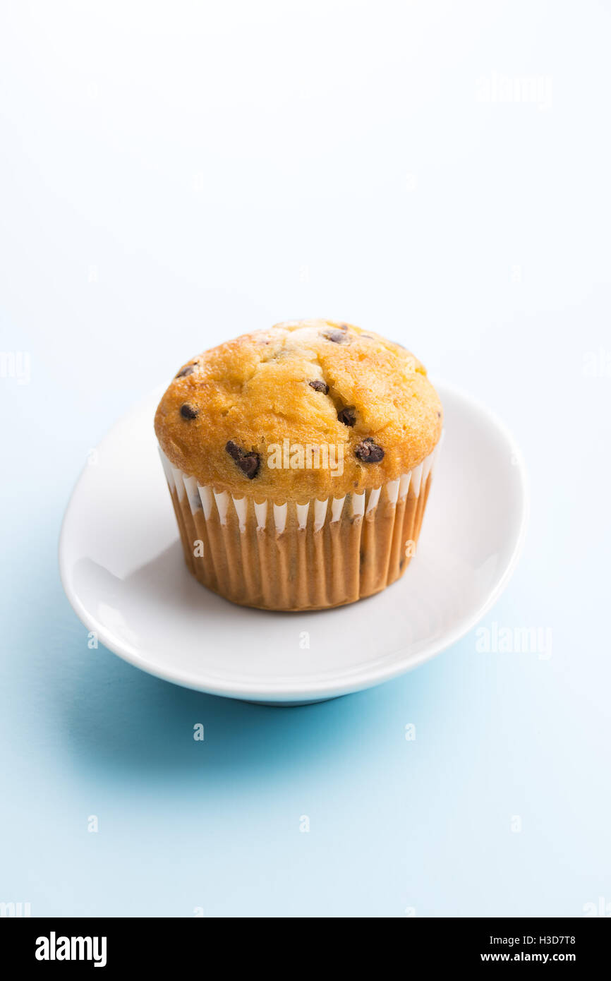 The tasty muffin with chocolate on blue background Stock Photo - Alamy
