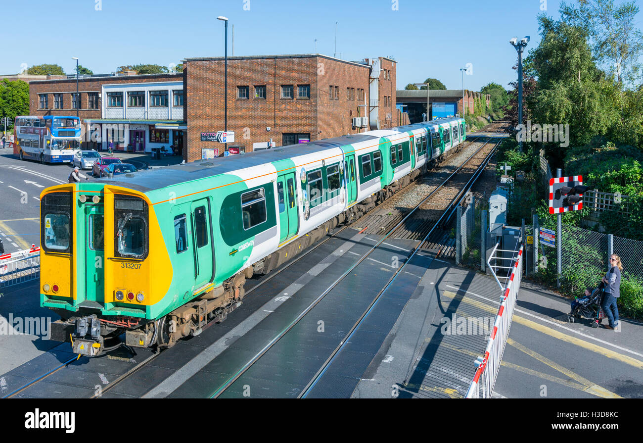 Southern Railway Coastway Class 313 train going across a level crossing ...