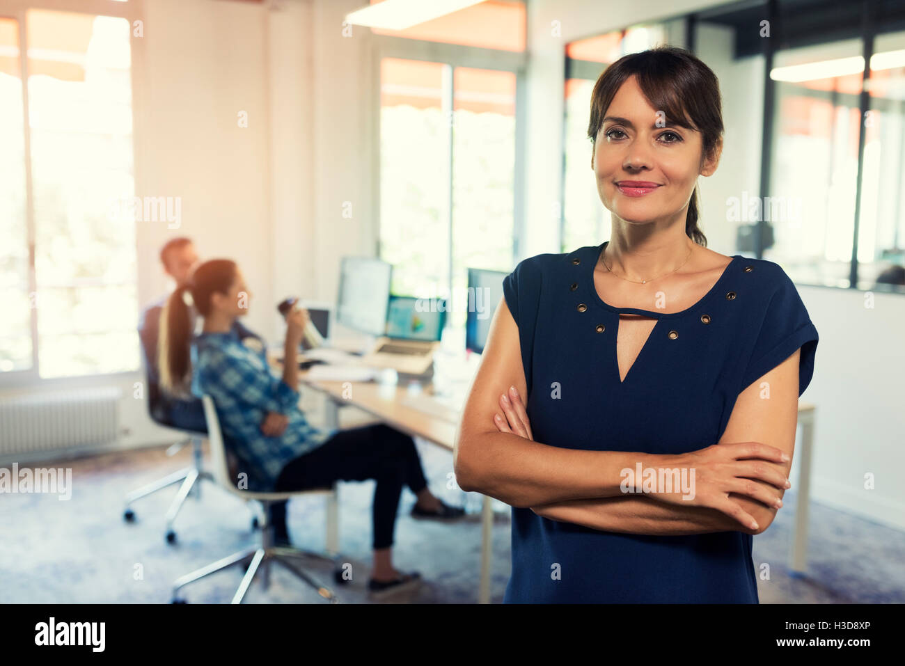 Portrait of successful woman boss in modern office space. Looking at ...