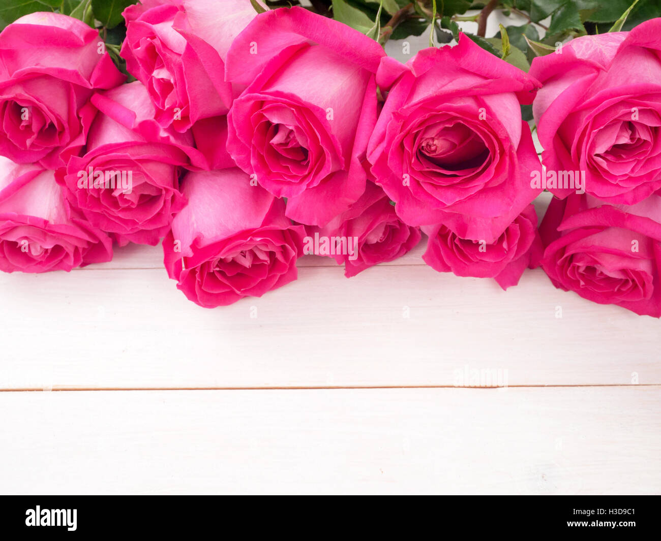 Pink roses bouquet on the rustic background Stock Photo - Alamy