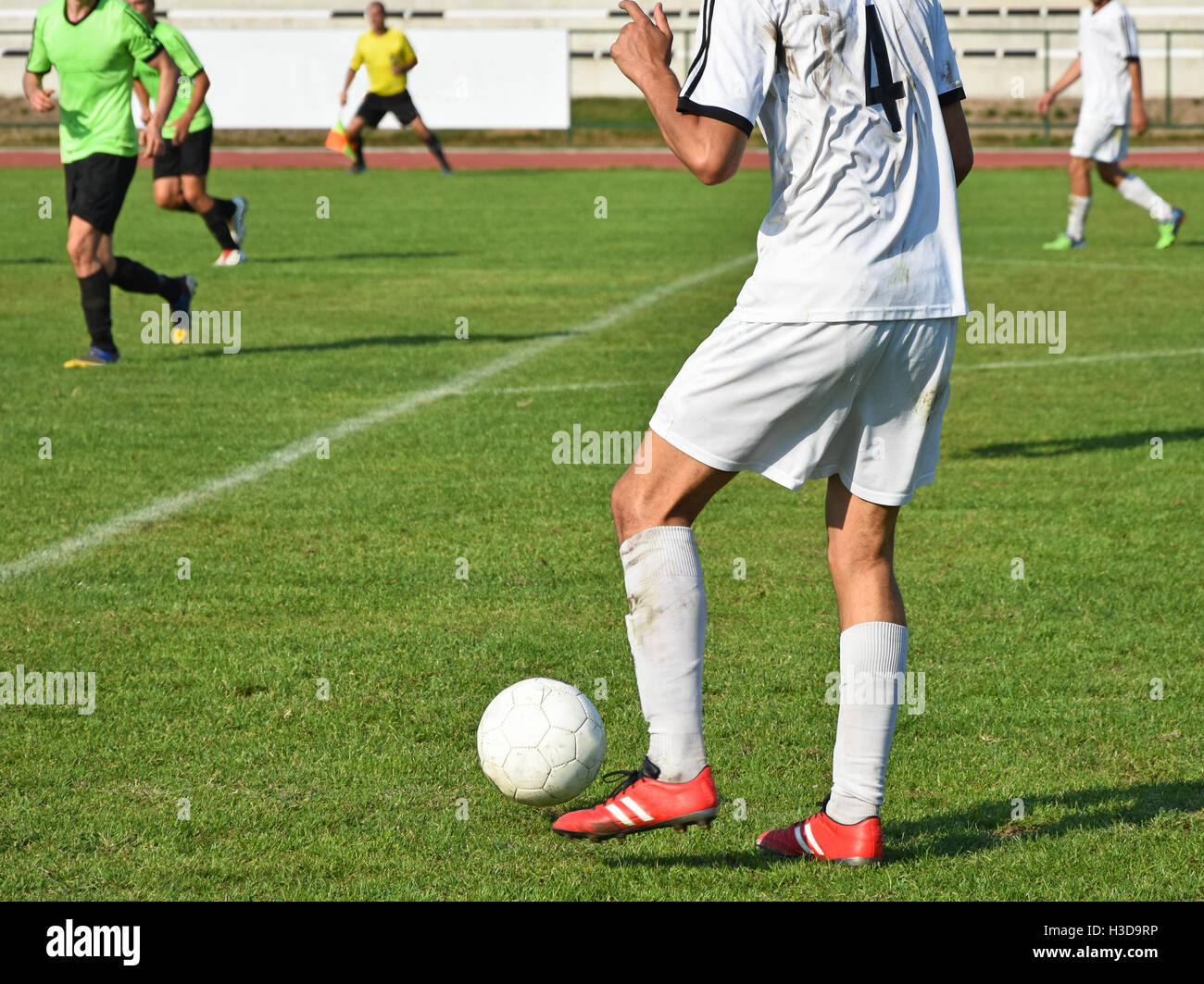 Men are playing soccer outdoors Stock Photo - Alamy