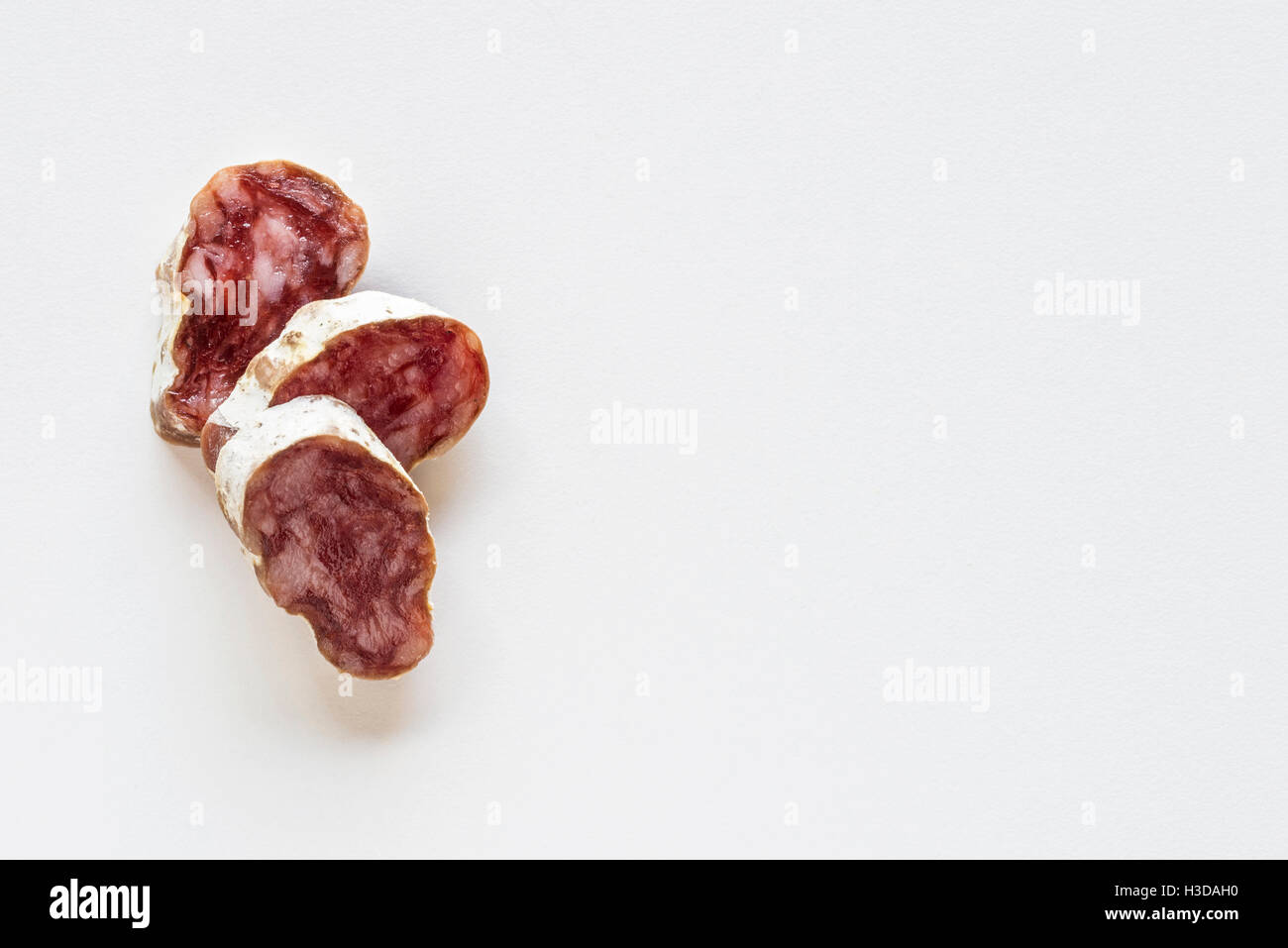 Three slices of Catalan sausage called fuet isolated on white ...