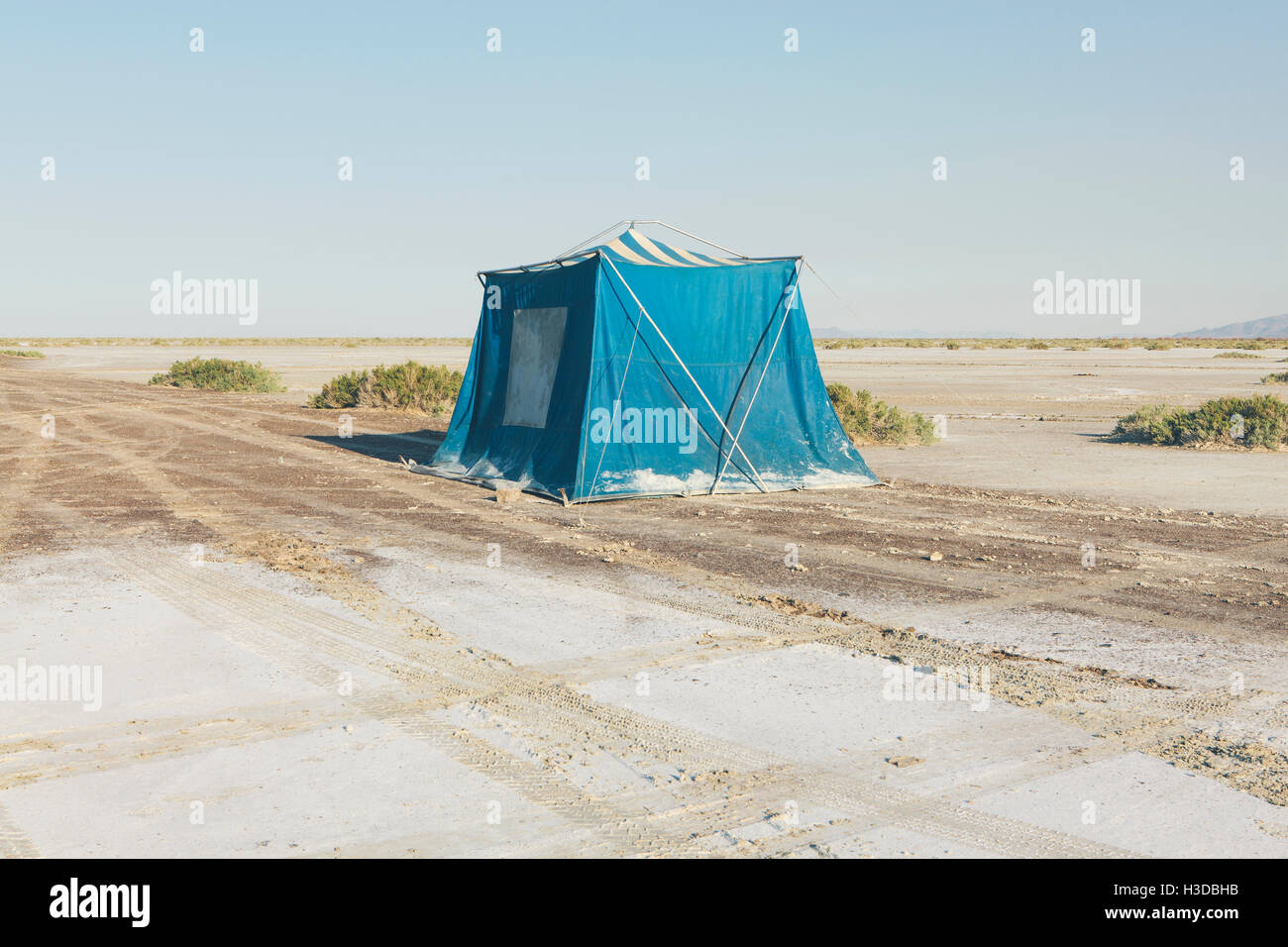 Old muddy blue camping tent in the desert of the Bonneville Salt Flats ...