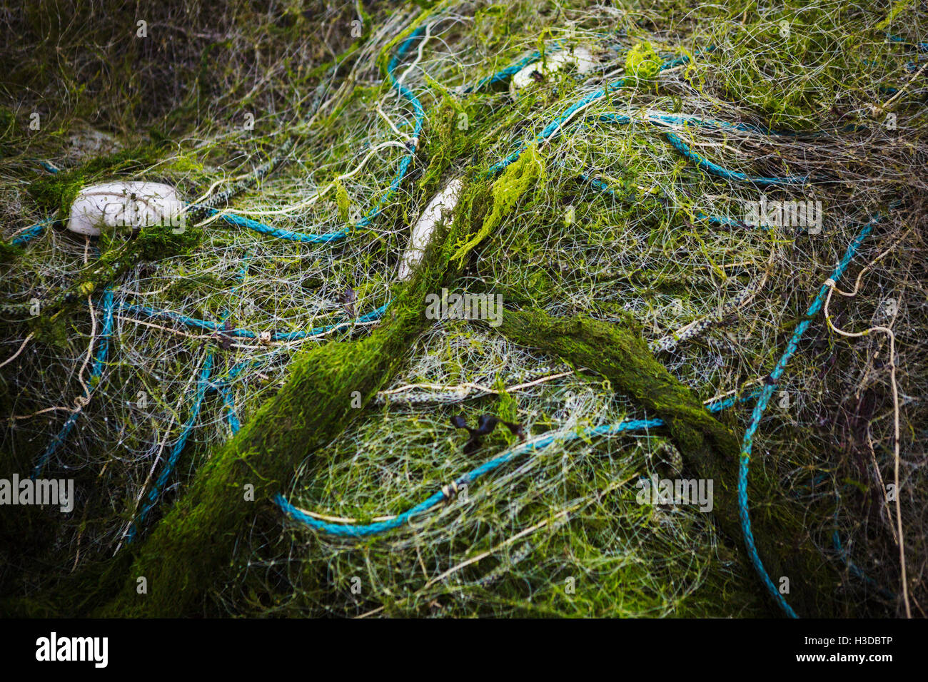 Heaped up fishing nets with floats Stock Photo - Alamy