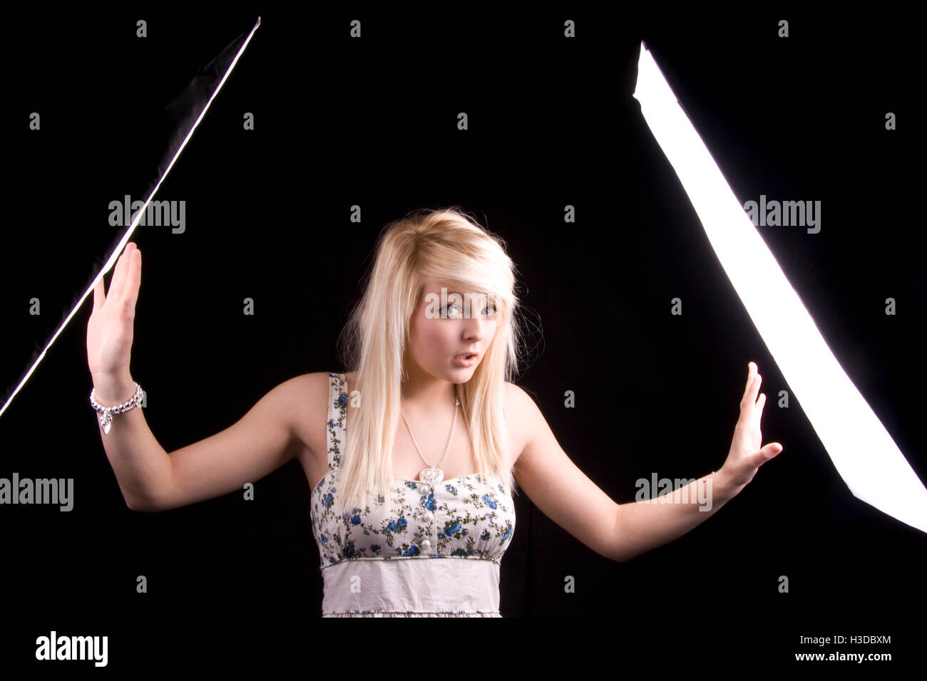 Young woman posing with studio lights Stock Photo - Alamy