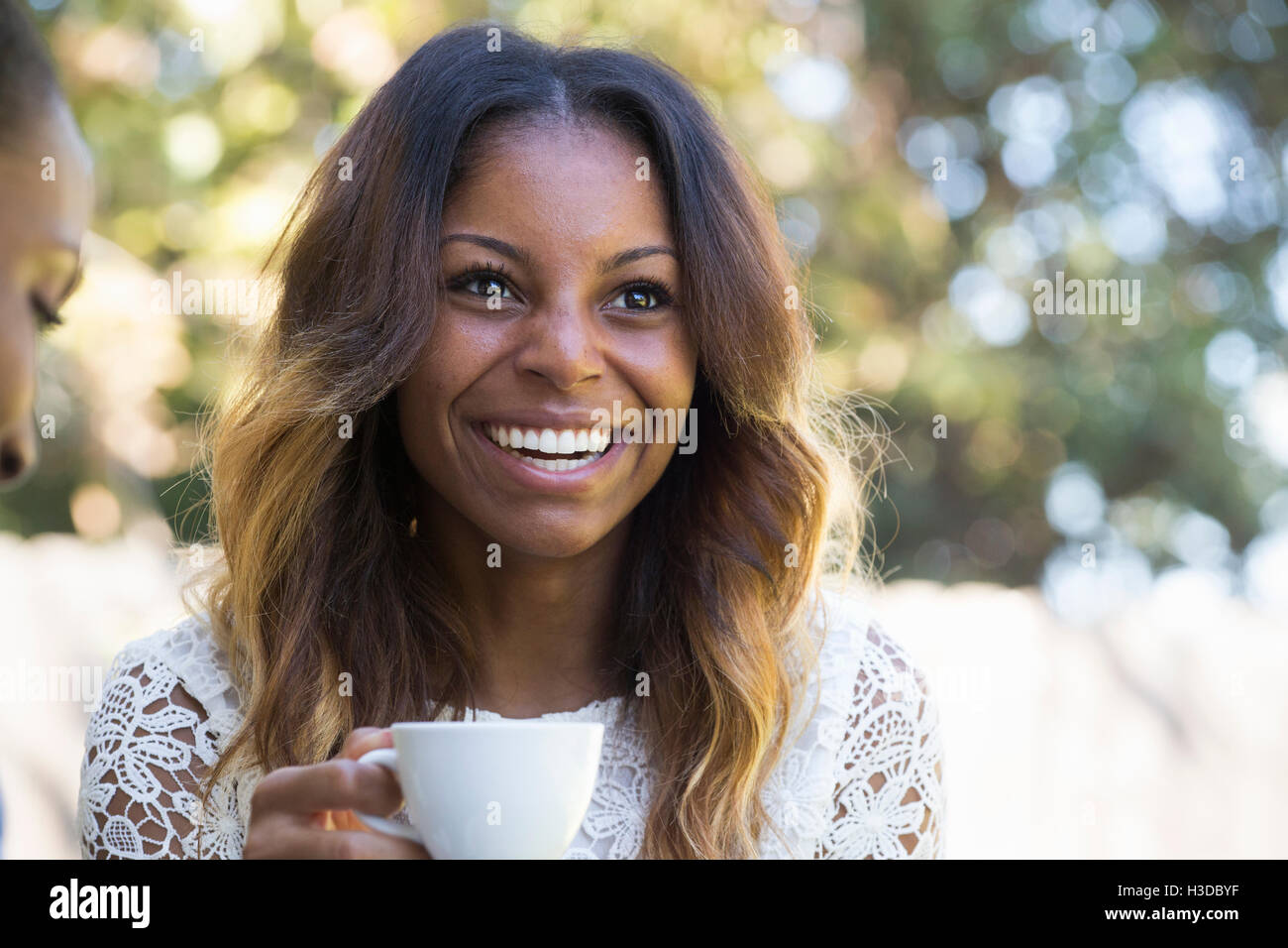 Portrait of a smiling woman with long brown hair Stock Photo - Alamy