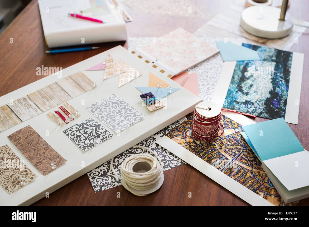 Craft materials, fabric and paper, patterns and a notebook and tablet ...