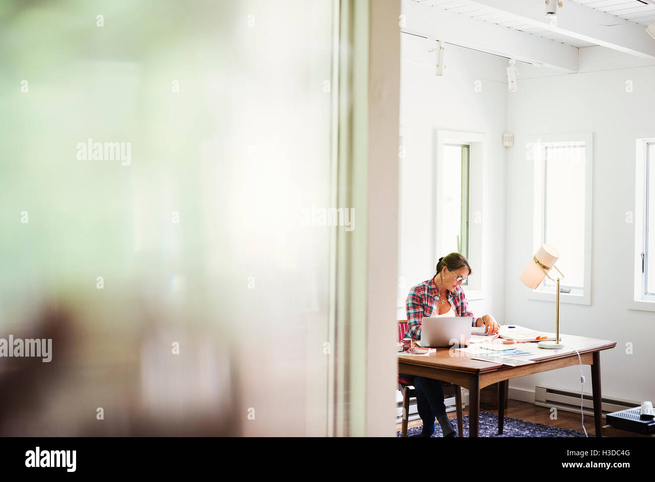 A woman creating a collage picture with material and paper Stock Photo ...