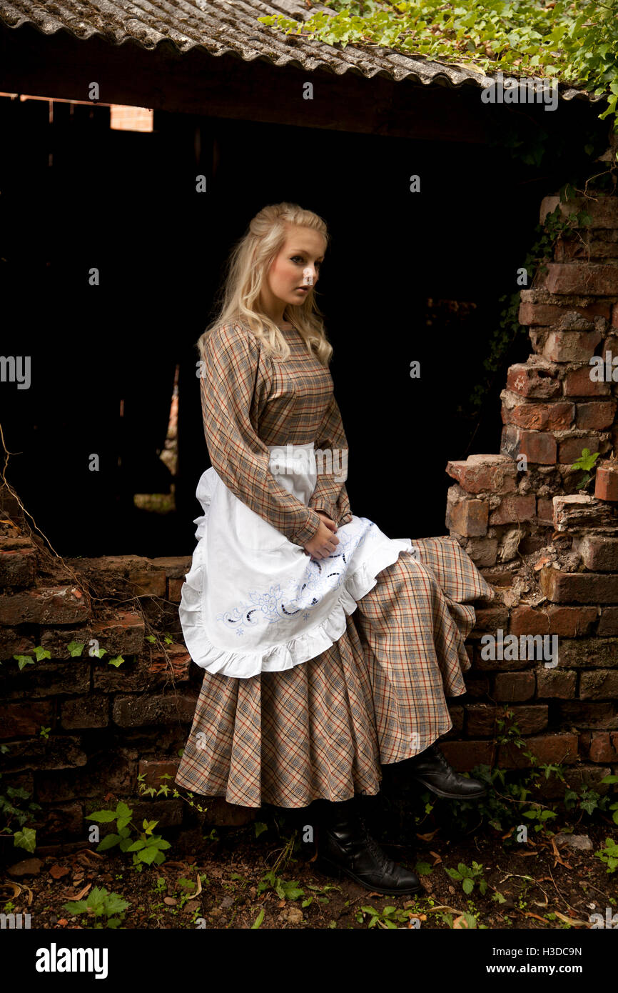 Young woman in vintage dress as a servant Stock Photo - Alamy