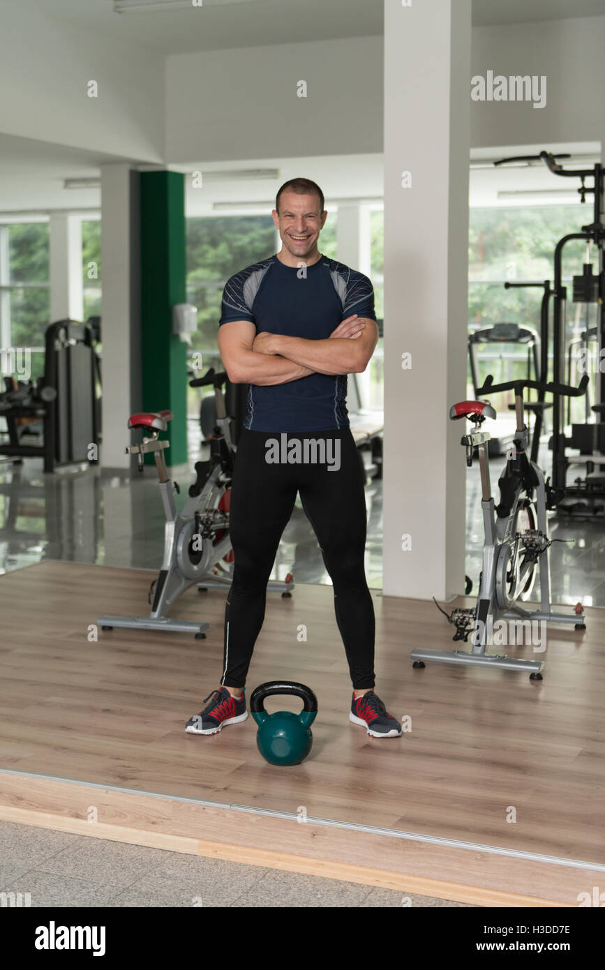 Man Working Out With Kettle Bell In A Gym - Bodybuilder Doing Heavy ...